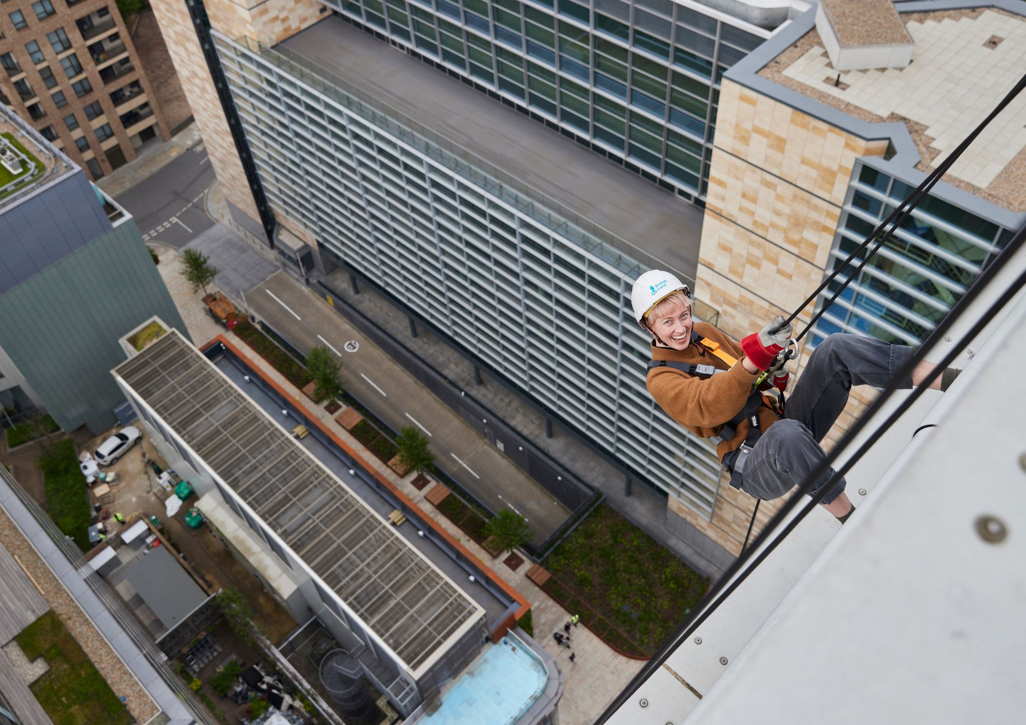Who roped us into this? Eighty daredevils abseil down skyscraper ...